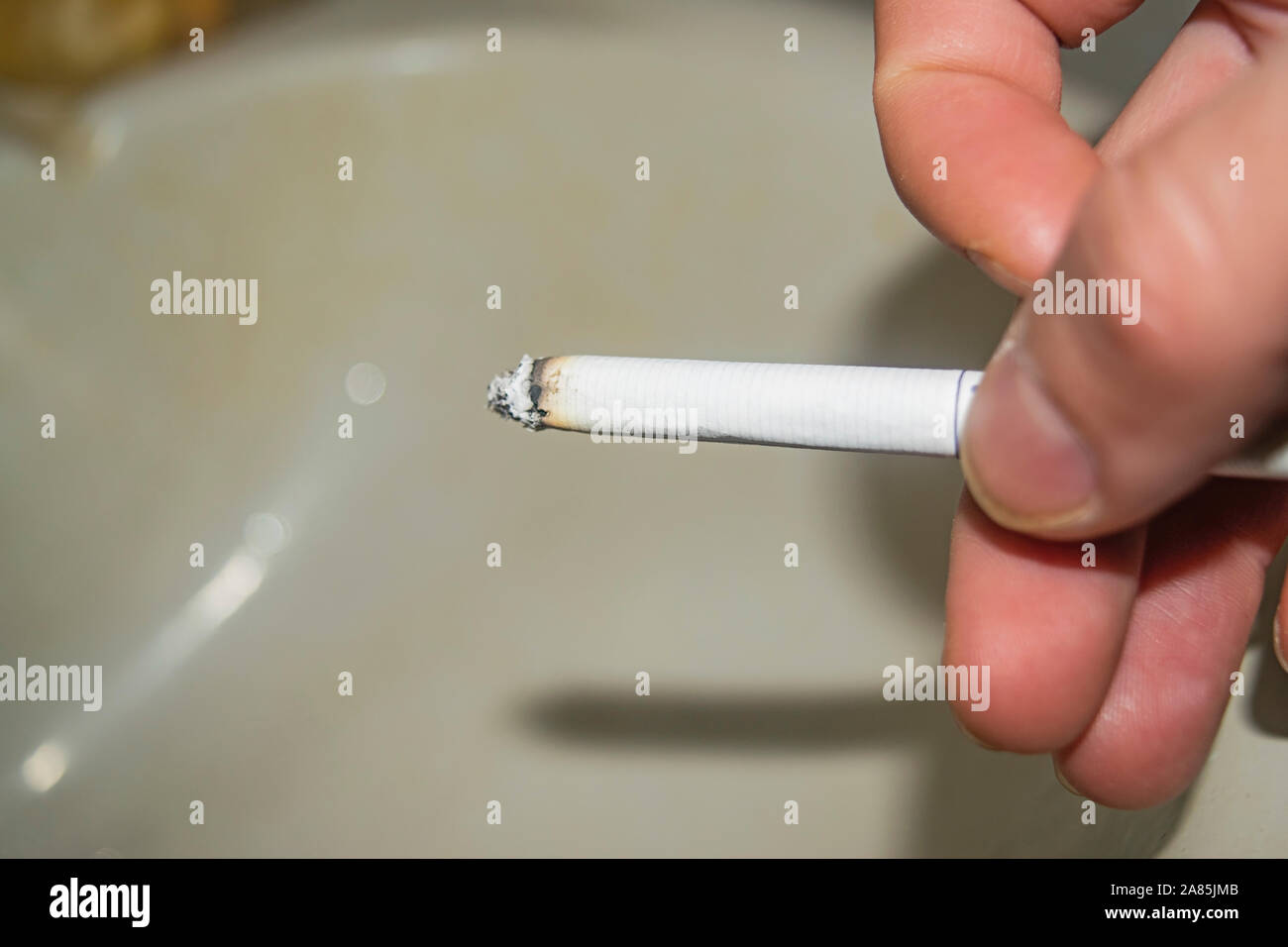 Cigarette in a man's hand concept photo. The dangers of Smoking ...