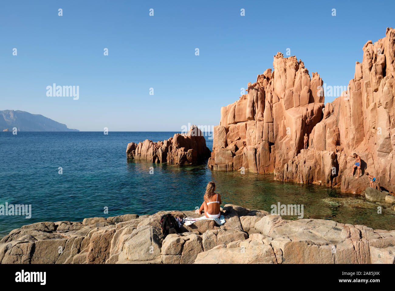 Tourists enjoying the Rocce rosse / Porphyry Red Rocks Beach Arbatax ...