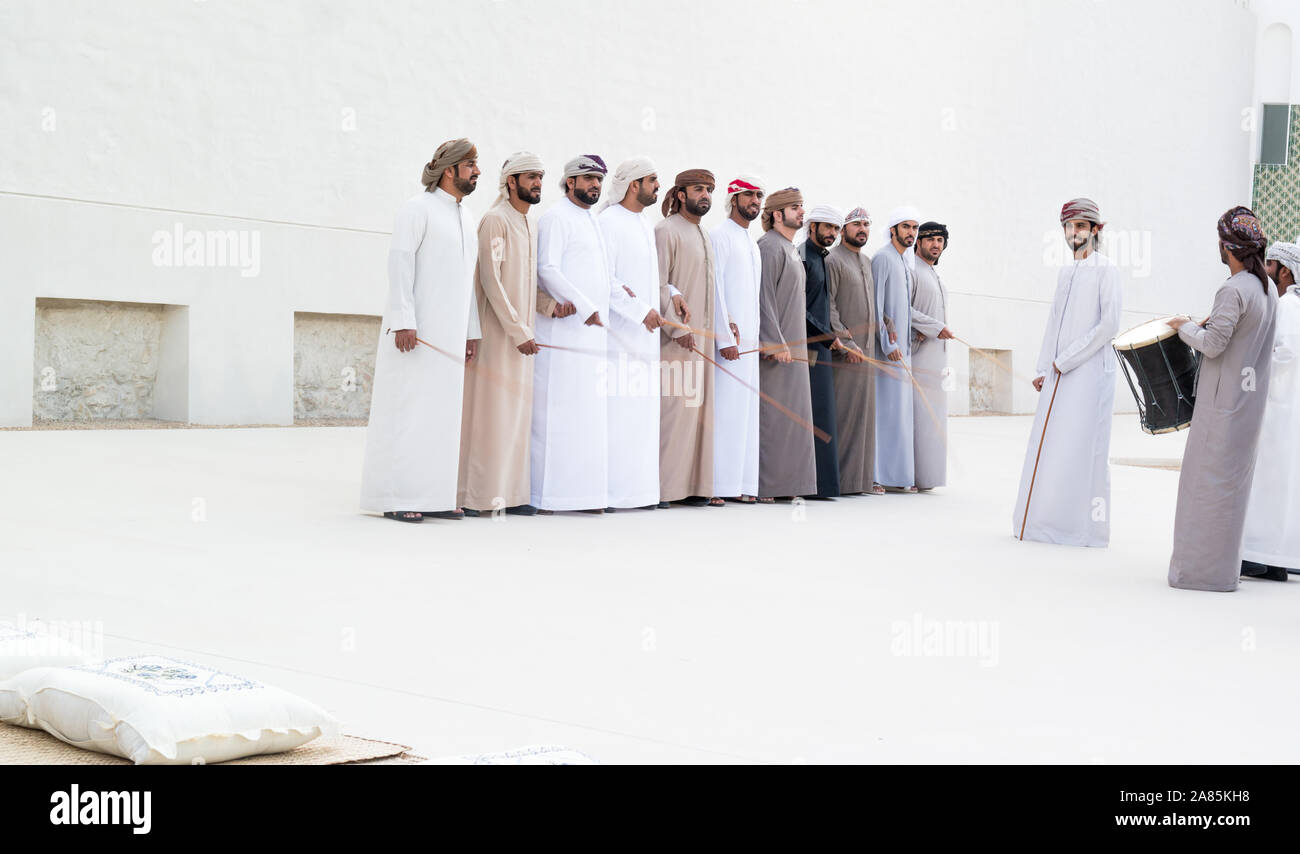 Emirati Men performing the Yowla, a traditional dance in the heritage ...
