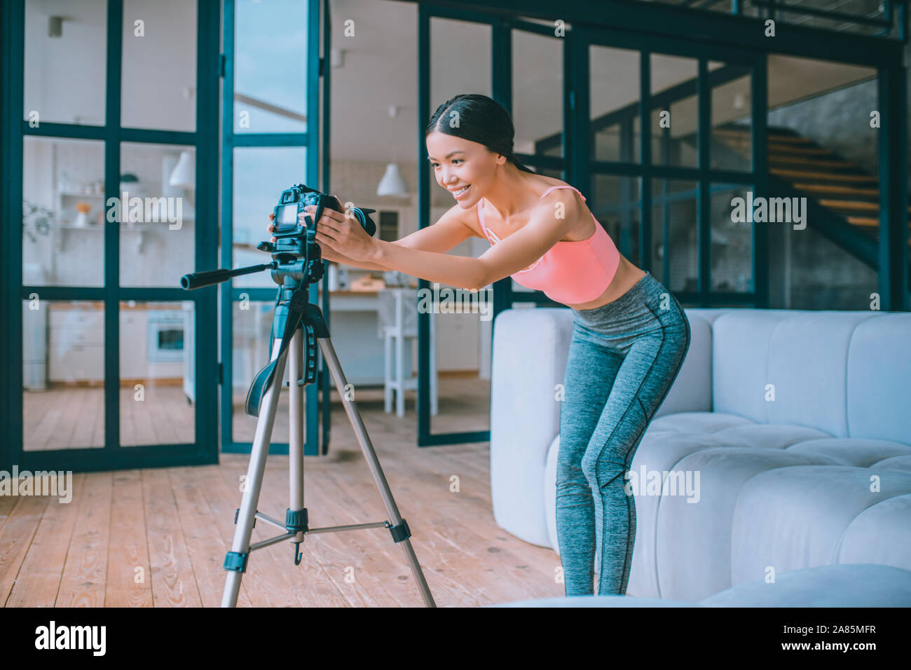 Fitness blogger fixing camera before making video Stock Photo - Alamy