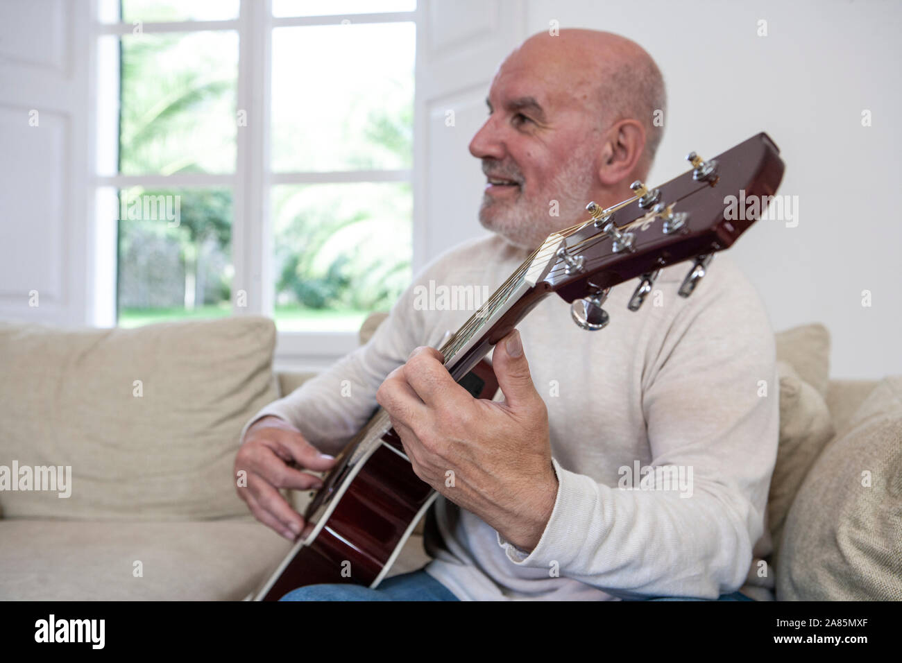 Senior man playing the guitar Stock Photo - Alamy