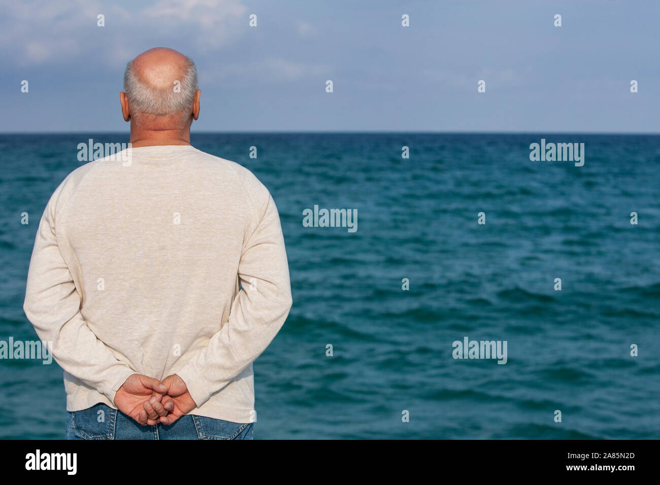 Elderly person looking out to sea hi-res stock photography and images ...