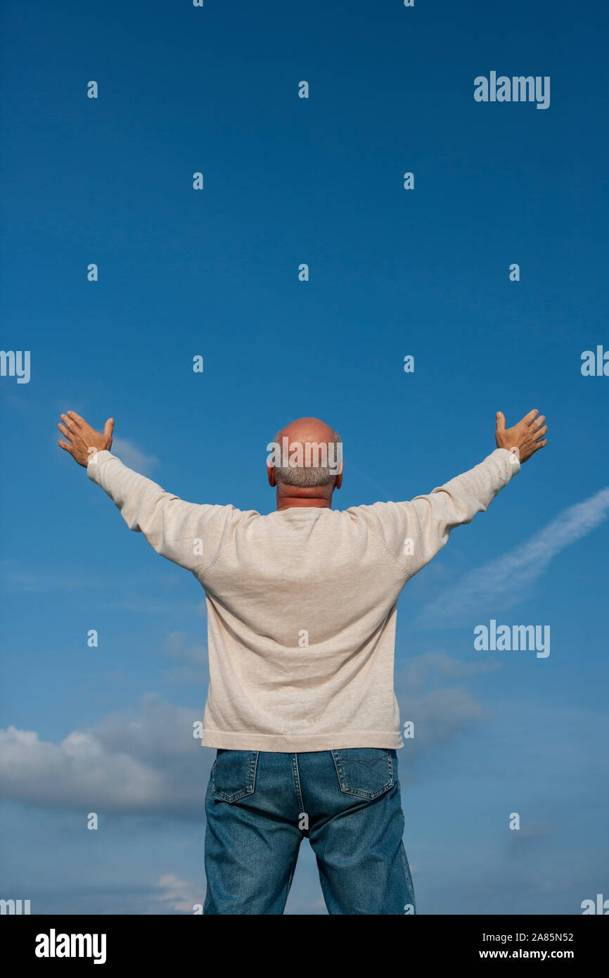 Back view of senior man holding his arms up Stock Photo - Alamy