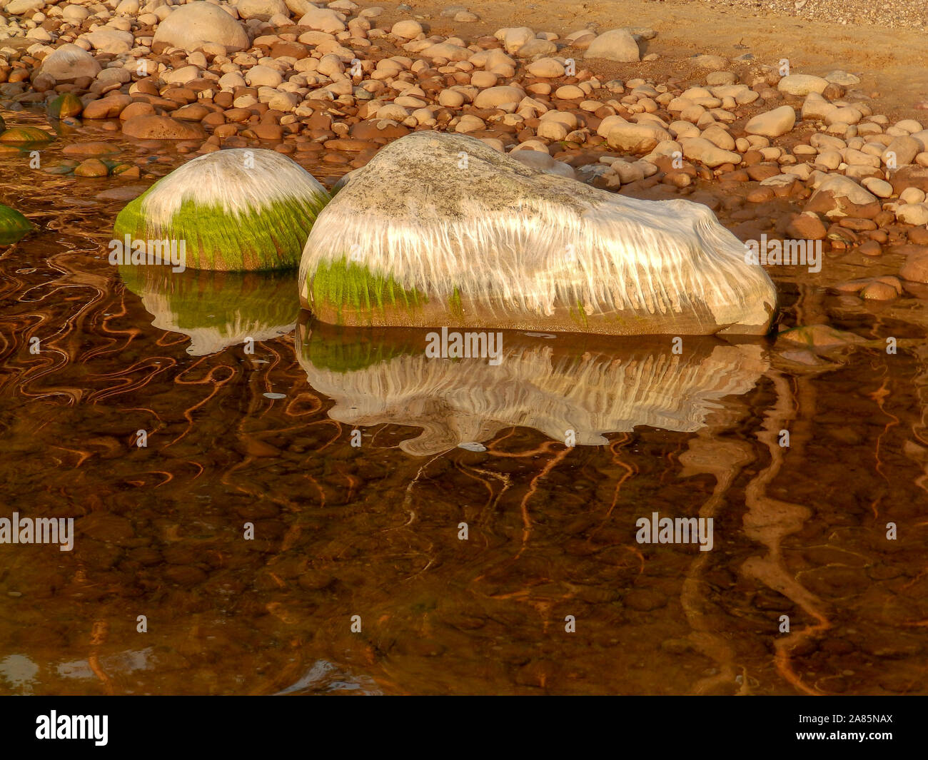 landscape with beautiful rocks by the sea, colorful reflections in the ...