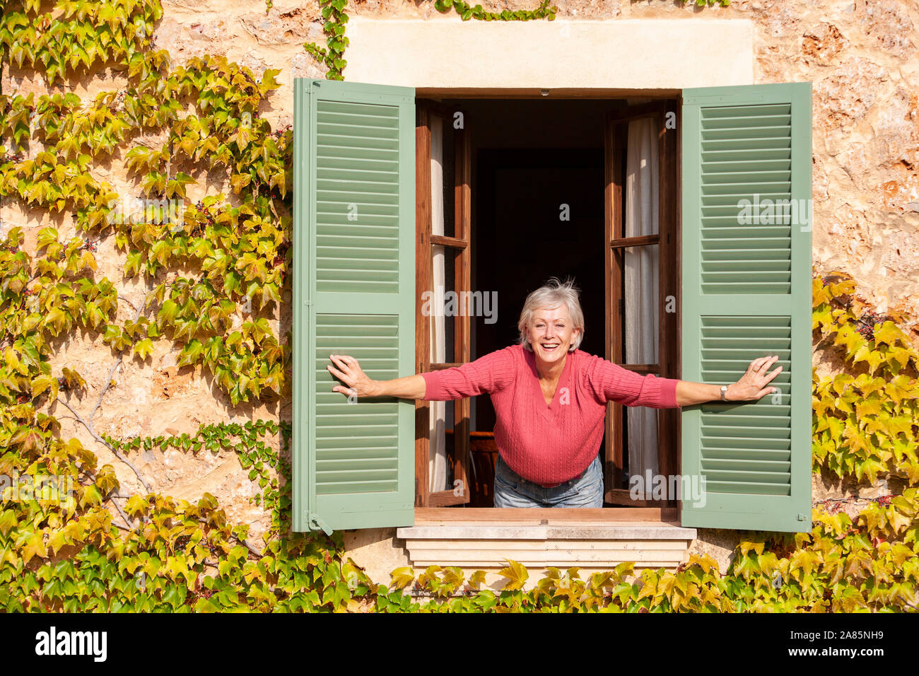 Woman opening shutters hi-res stock photography and images - Alamy