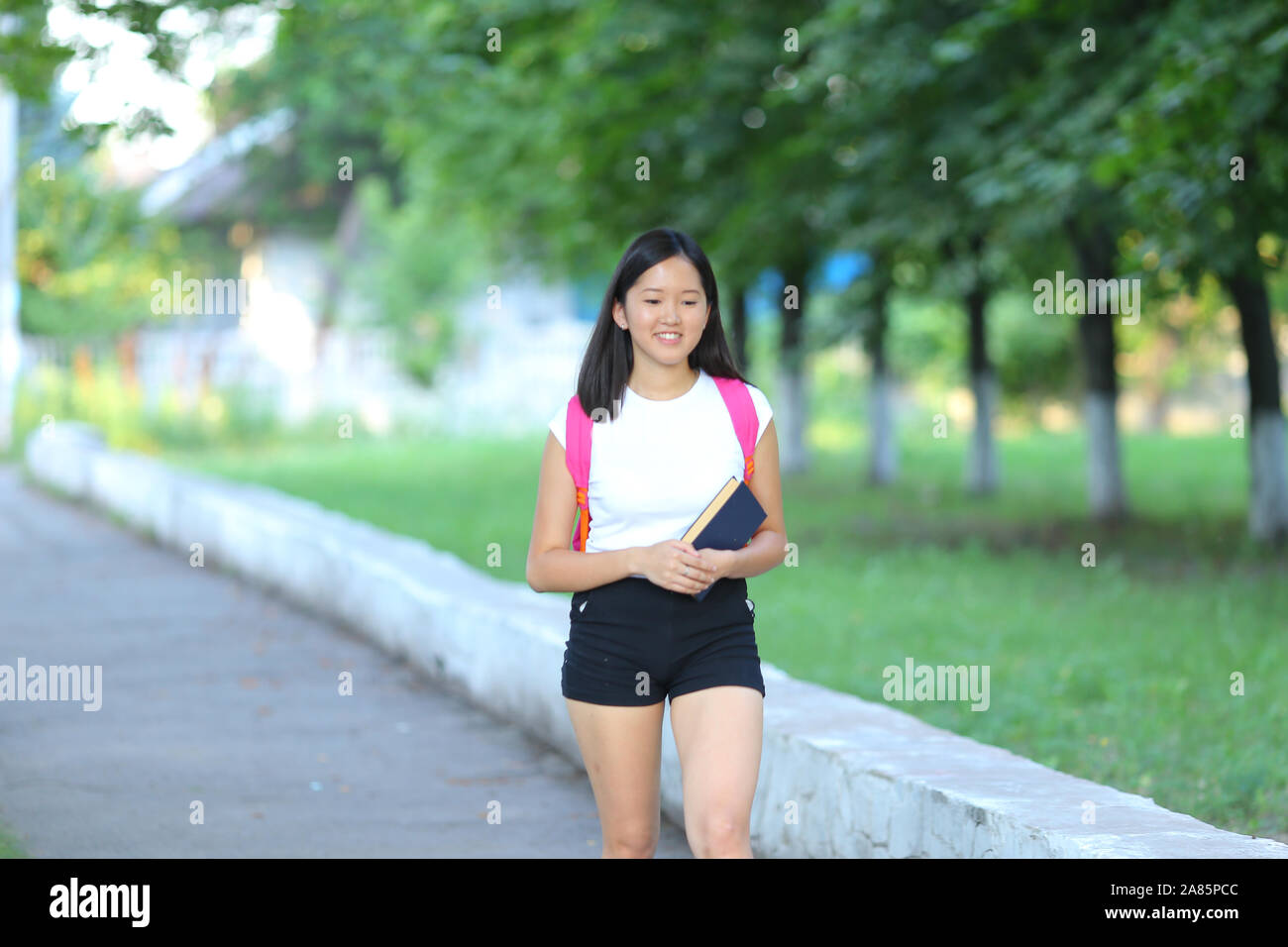Young girl walking in the park are walking gait Stock Photo - Alamy