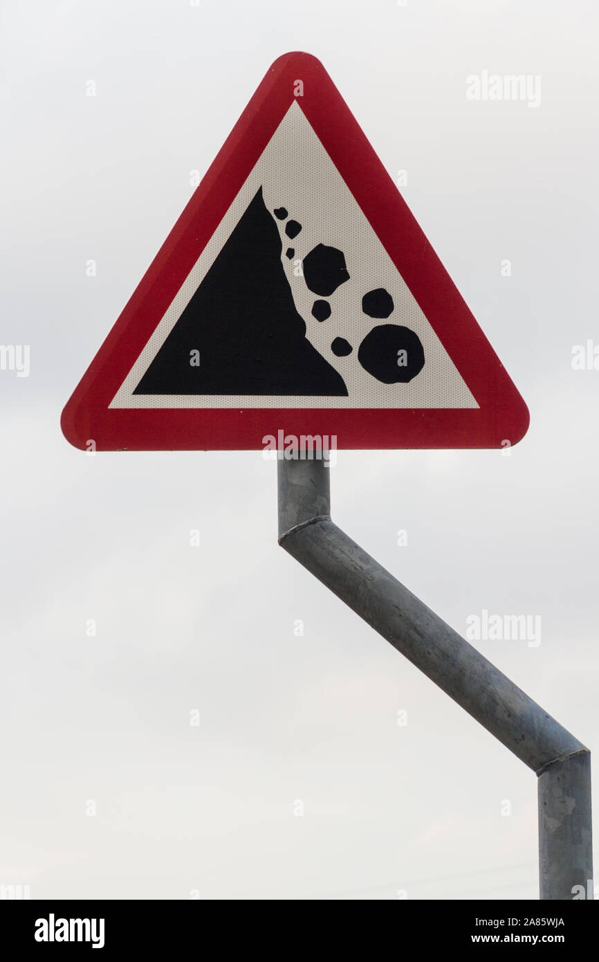 Triangular UK warning or hazard sign for Falling or fallen rocks ...