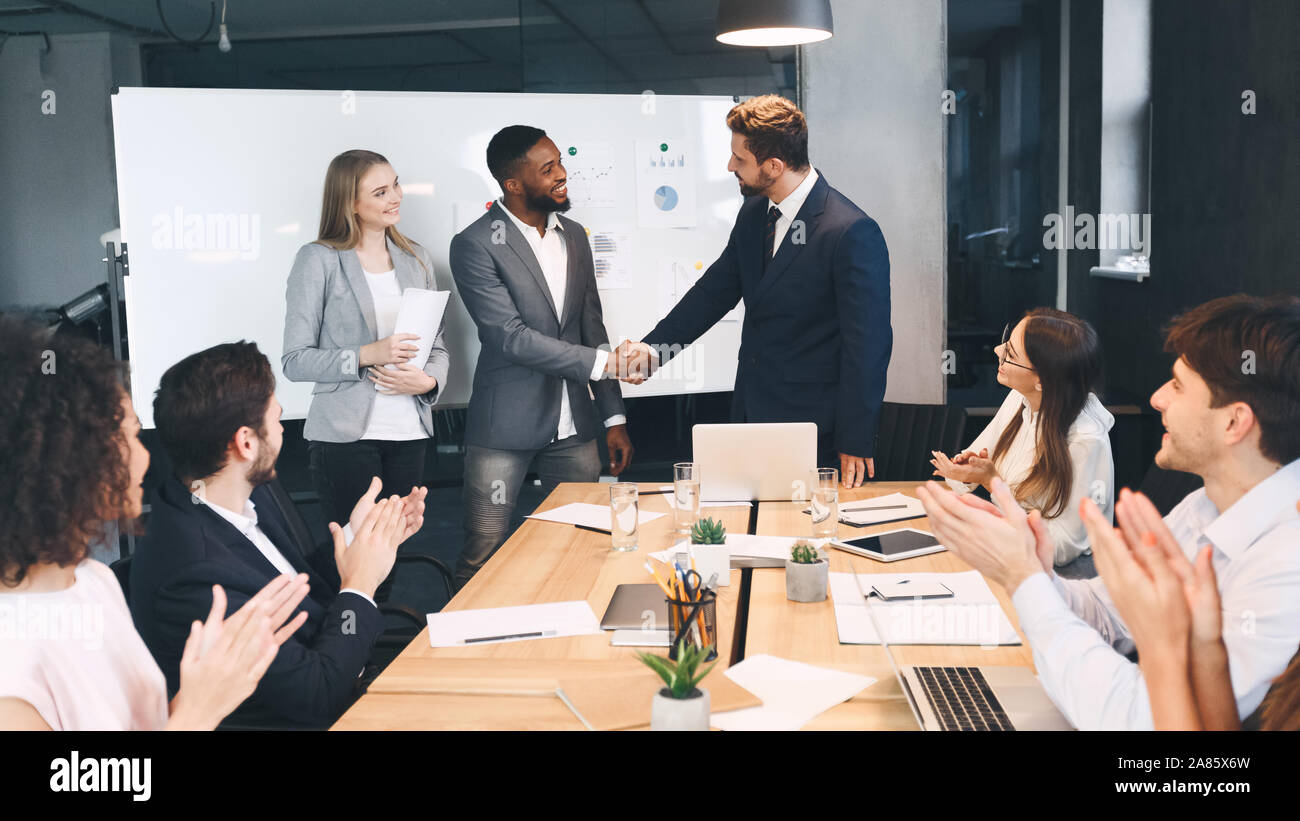 Contract conclusion. Business partners shaking hands in office Stock ...