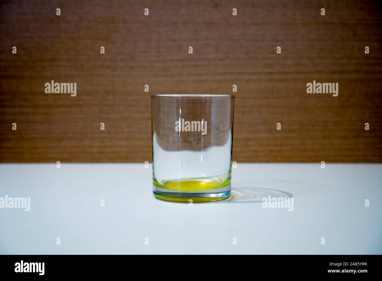 Empty glass beaker on the white table Stock Photo - Alamy