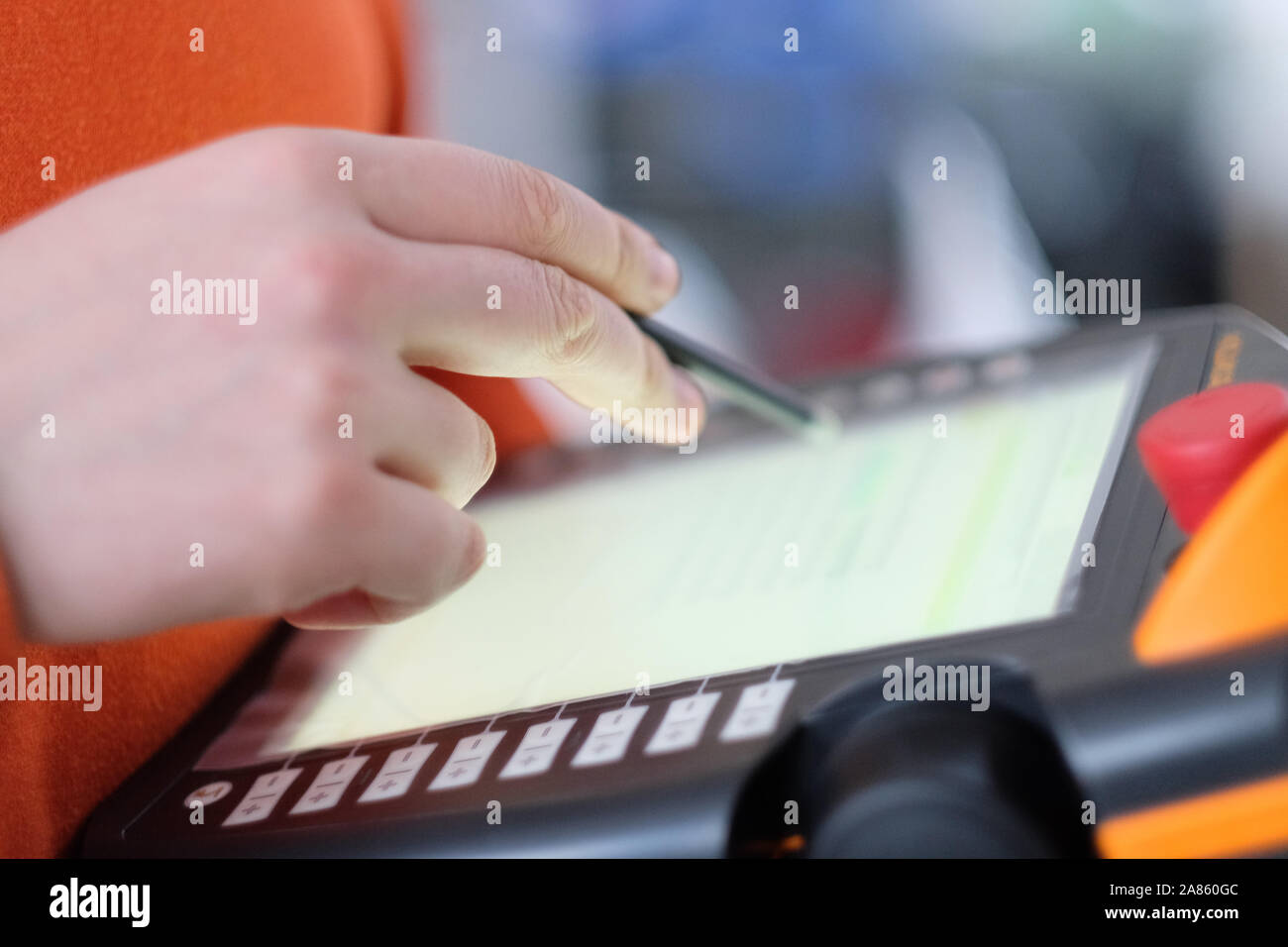 Hand with a pencil over an electronic control panel for special ...
