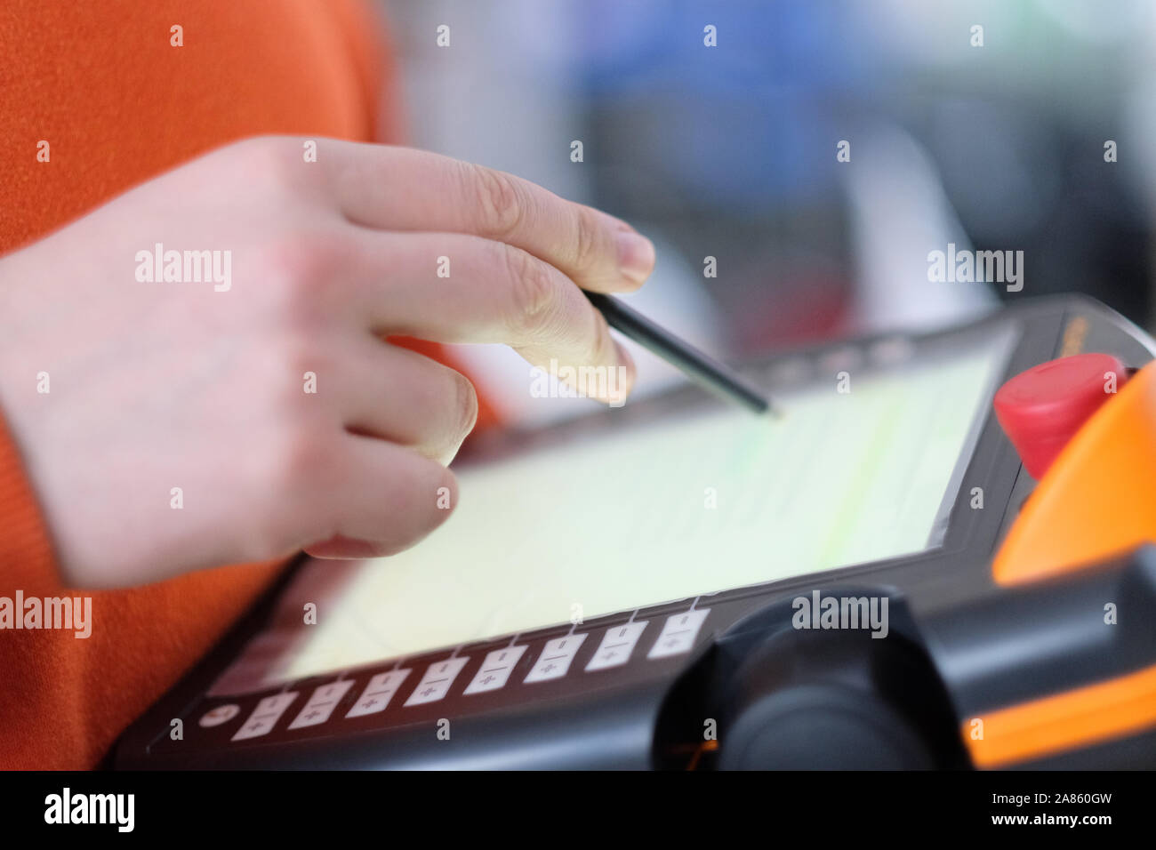 Hand with a pencil over an electronic control panel for special ...