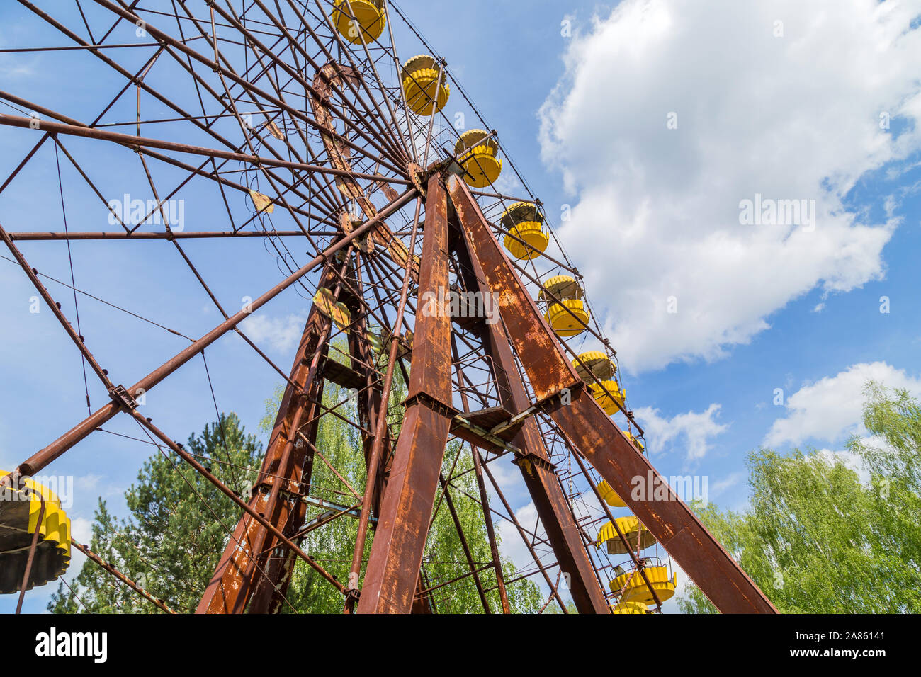 Old broken rusty metal radioactive electric wheel abandoned, the park ...