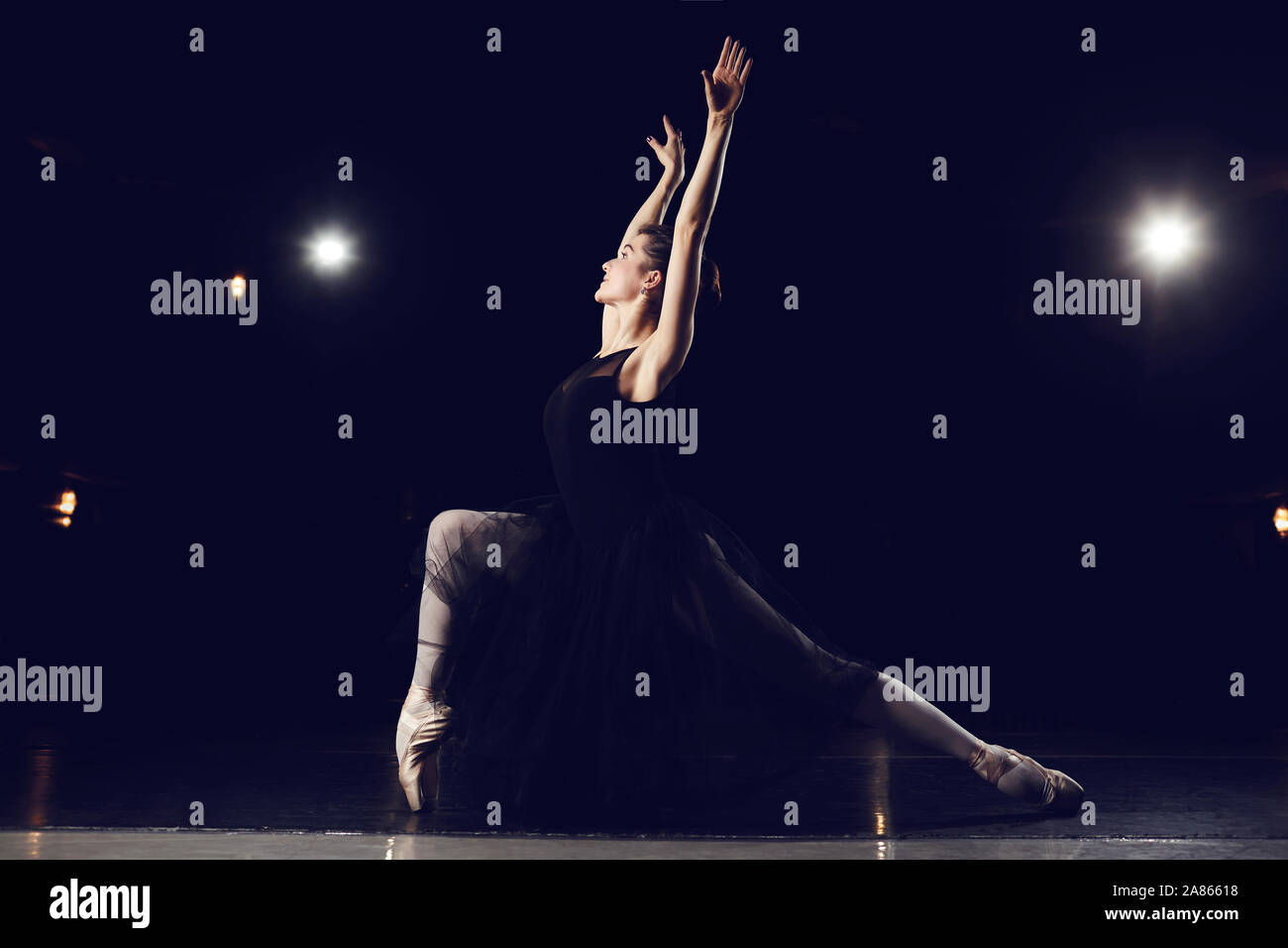 Woman ballet dancer on black background Stock Photo - Alamy
