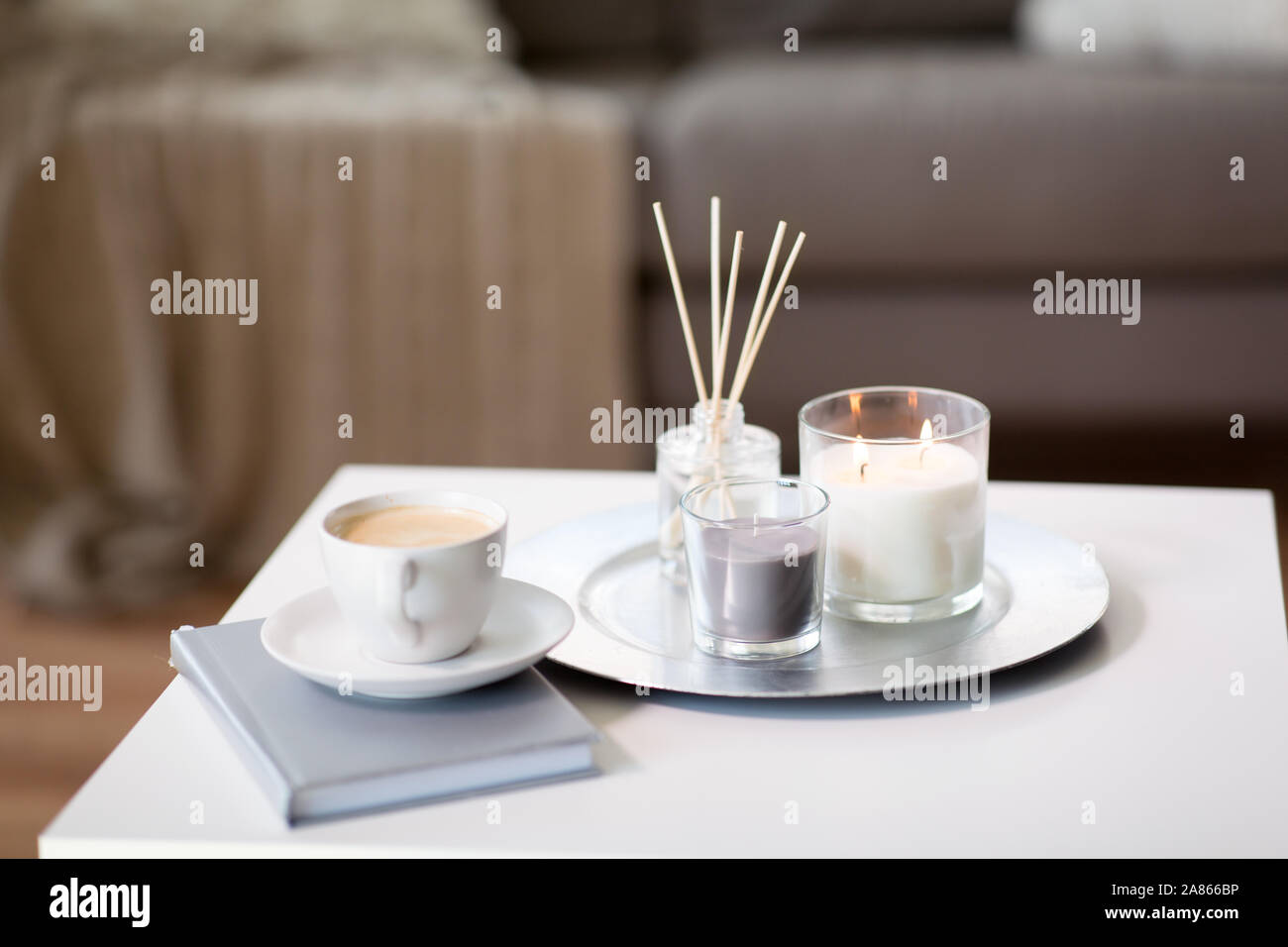 coffee, candles and aroma reed diffuser on table Stock Photo - Alamy
