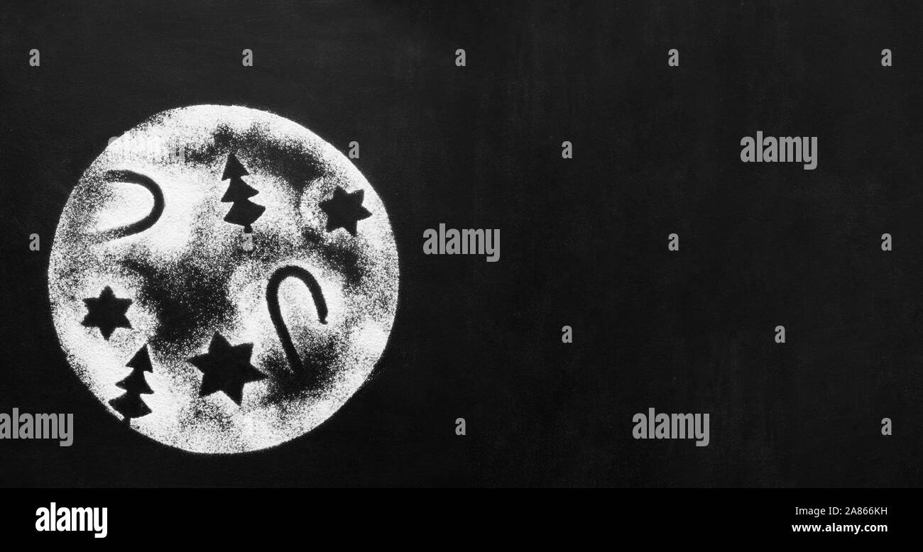 Full moon of sugar with cut of figures on black Stock Photo - Alamy