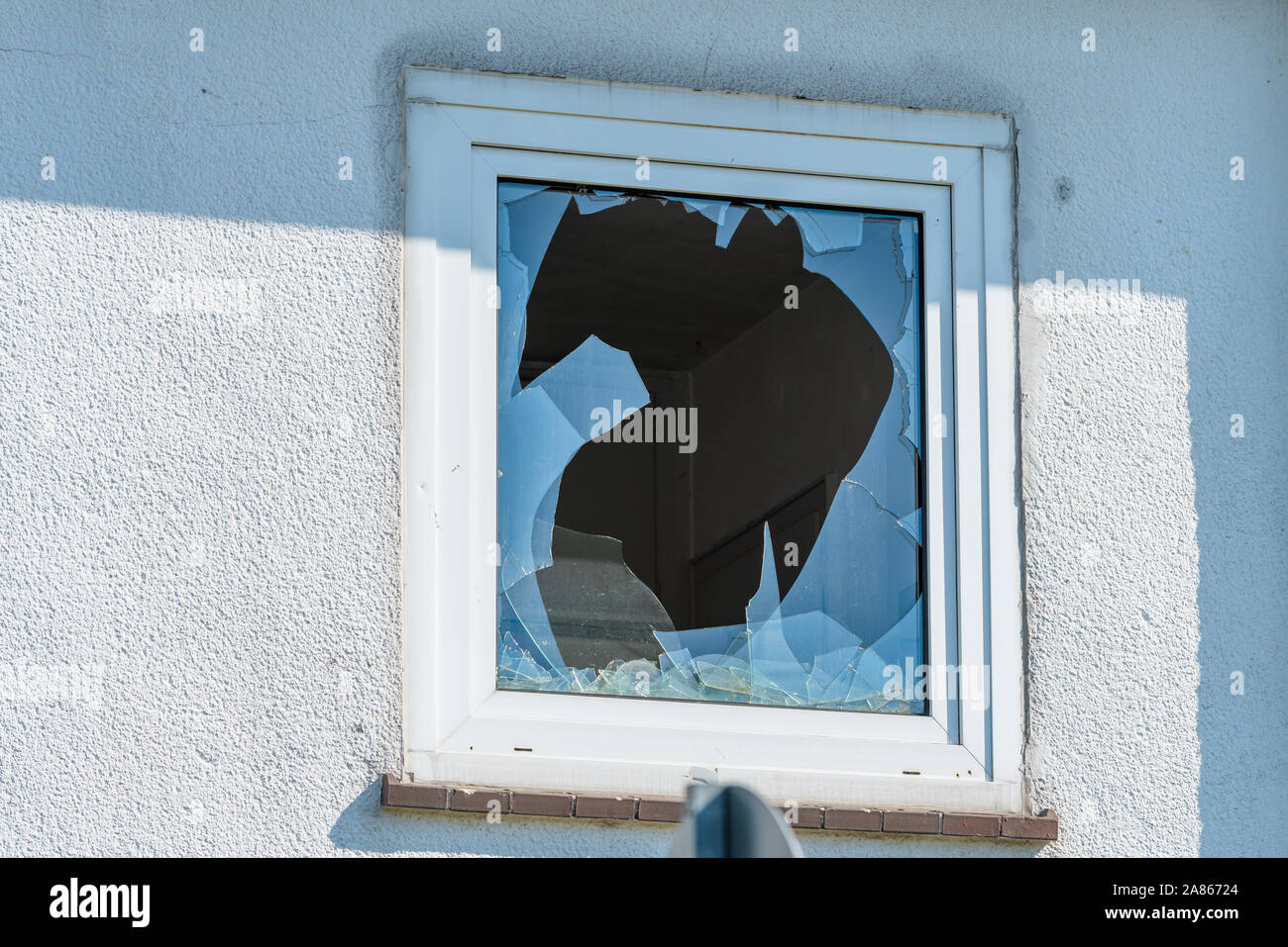 window with cracked glass after stone throw vandalism Stock Photo - Alamy