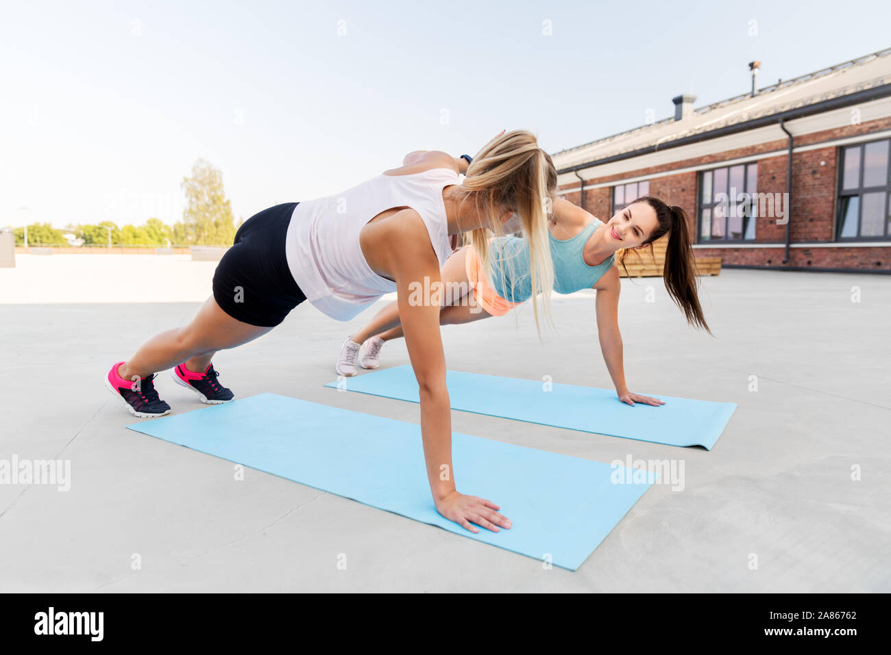 women making high five in side plank on sport mats Stock Photo - Alamy