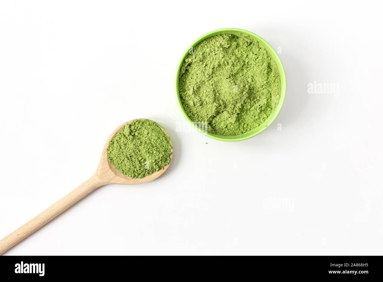 Wooden spoon with powdered matcha green tea in bowl, isolated on white ...