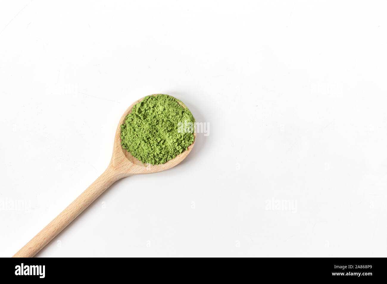 Wooden spoon with powdered matcha green tea in bowl, isolated on white ...