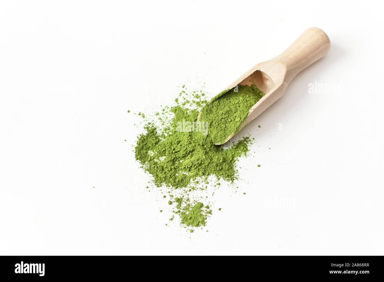 Wooden spoon with powdered matcha green tea in bowl, isolated on white ...