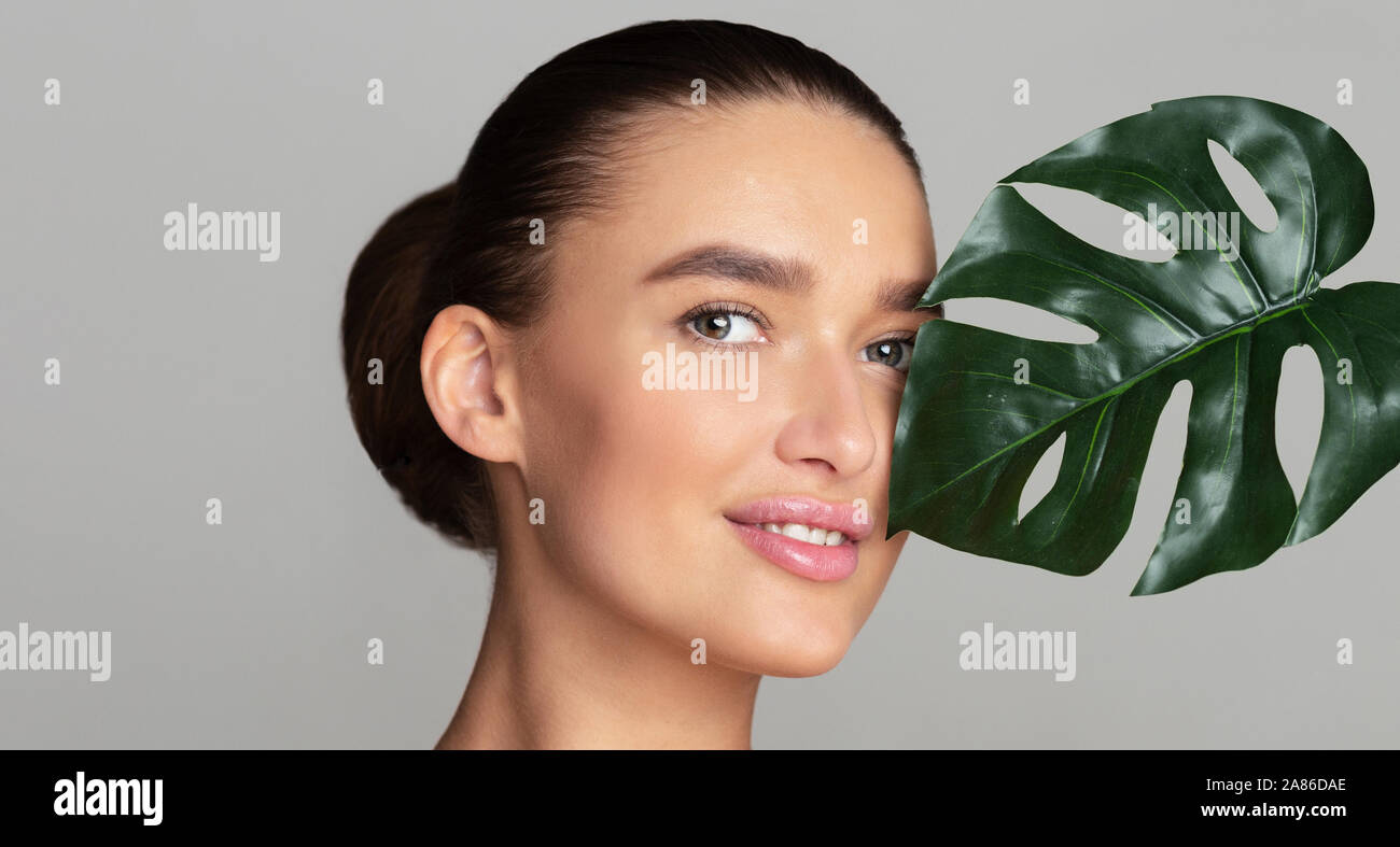 Woman posing green leaf hi-res stock photography and images - Alamy