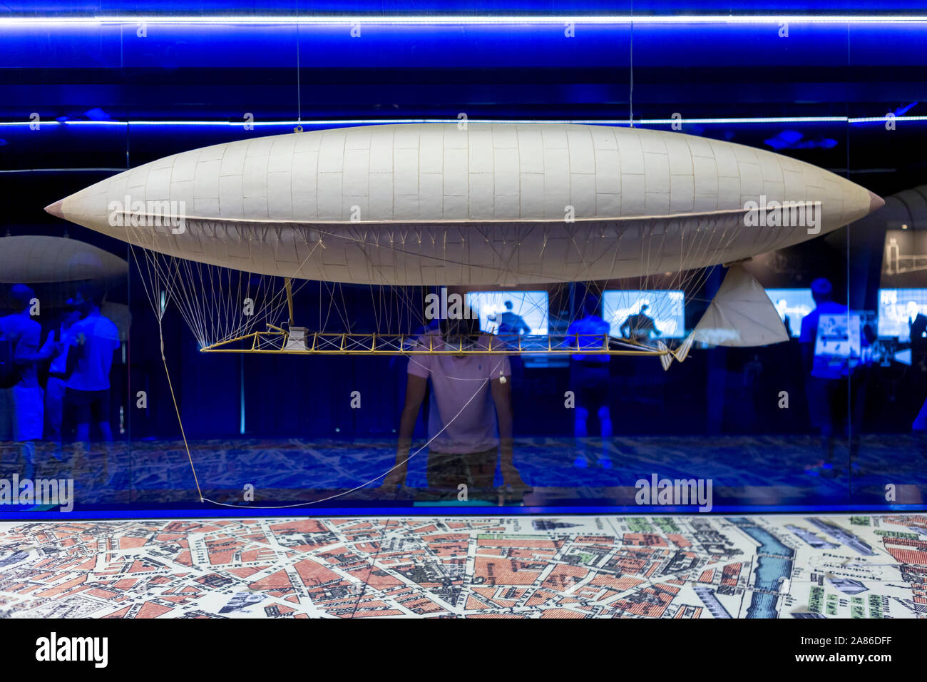 Exposition of historic aviation scaled model of a zeppelin above a map ...
