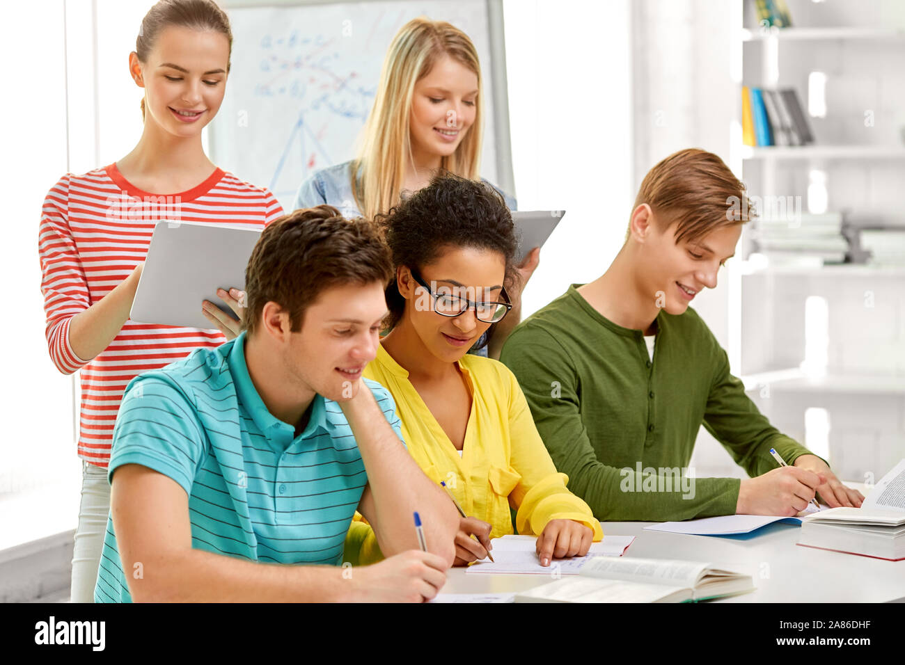 students with notebooks and tablet pc at school Stock Photo - Alamy