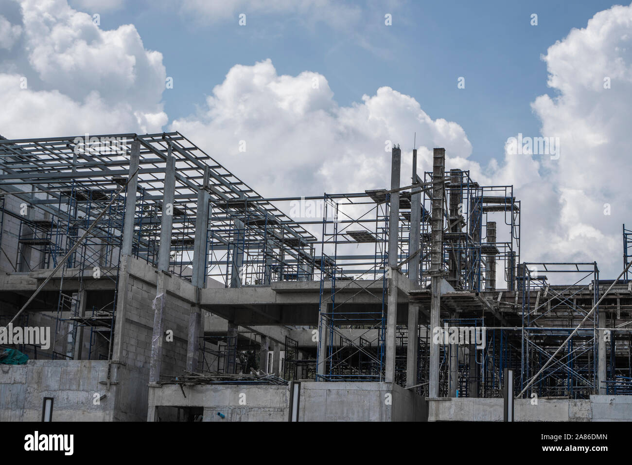 Building and Construction Site in progress. Building construction site against cloudy sky. Metal ...