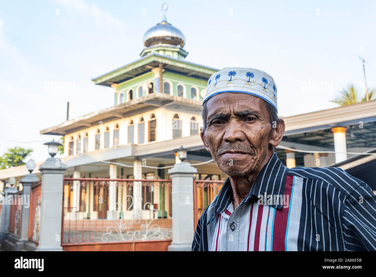 Indonesian muslim man standing in front of a mosque, East Java, Java ...