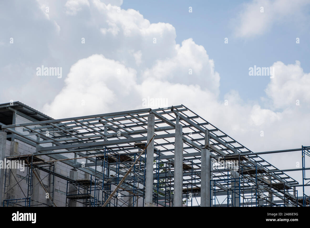 Building and Construction Site in progress. Building construction site against cloudy sky. Metal ...
