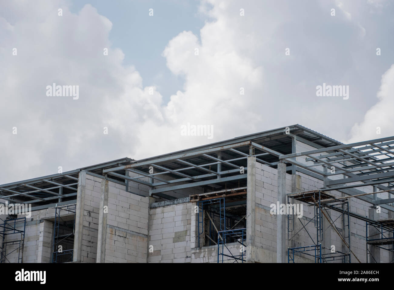 Building and Construction Site in progress. Building construction site against cloudy sky. Metal ...