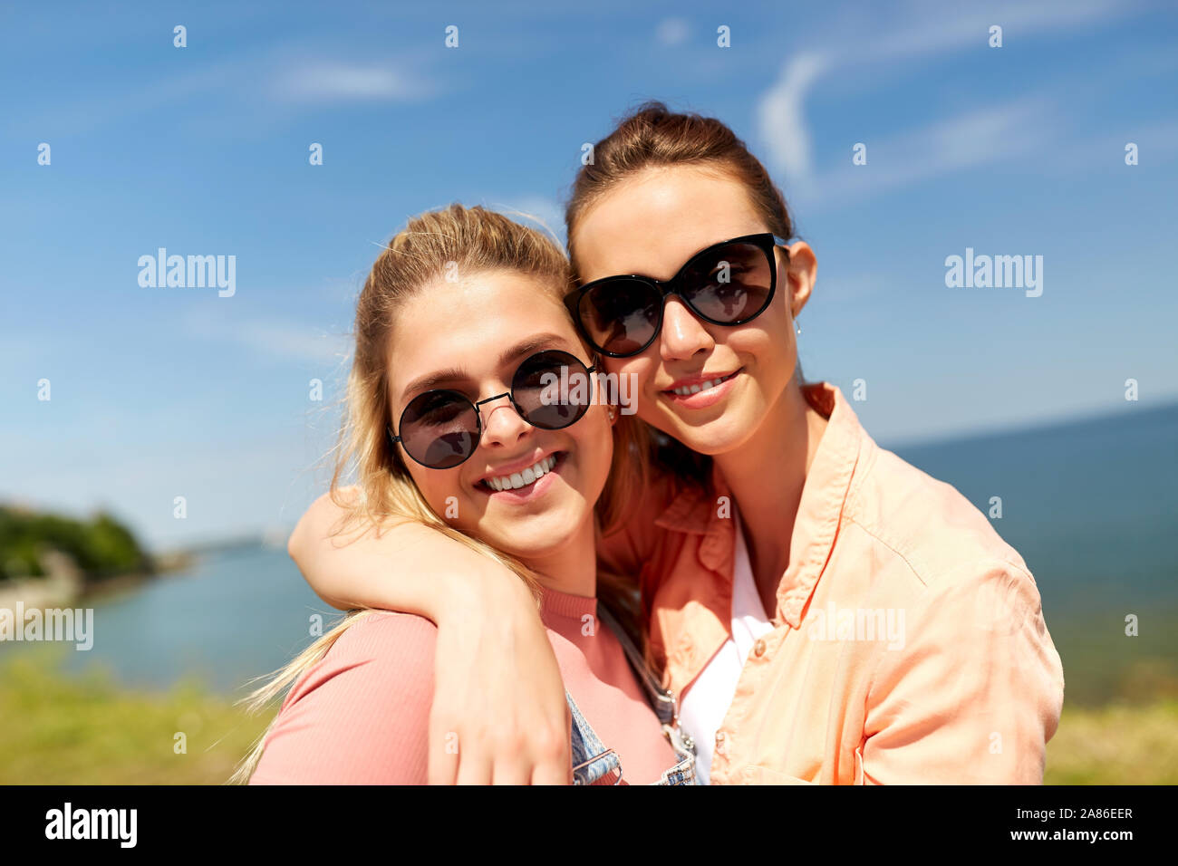 teenage girls or best friends at seaside in summer Stock Photo - Alamy
