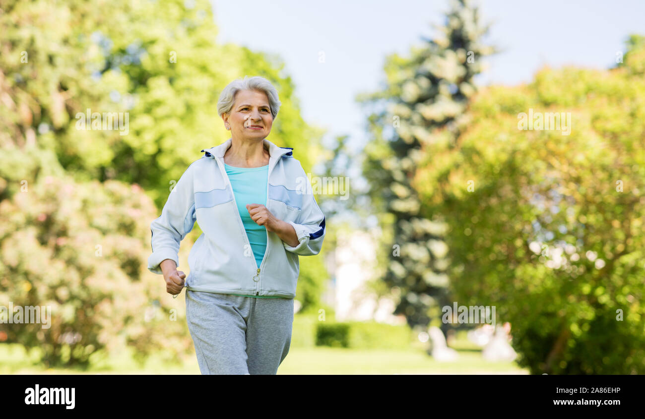 Fit female running along park hi-res stock photography and images - Alamy