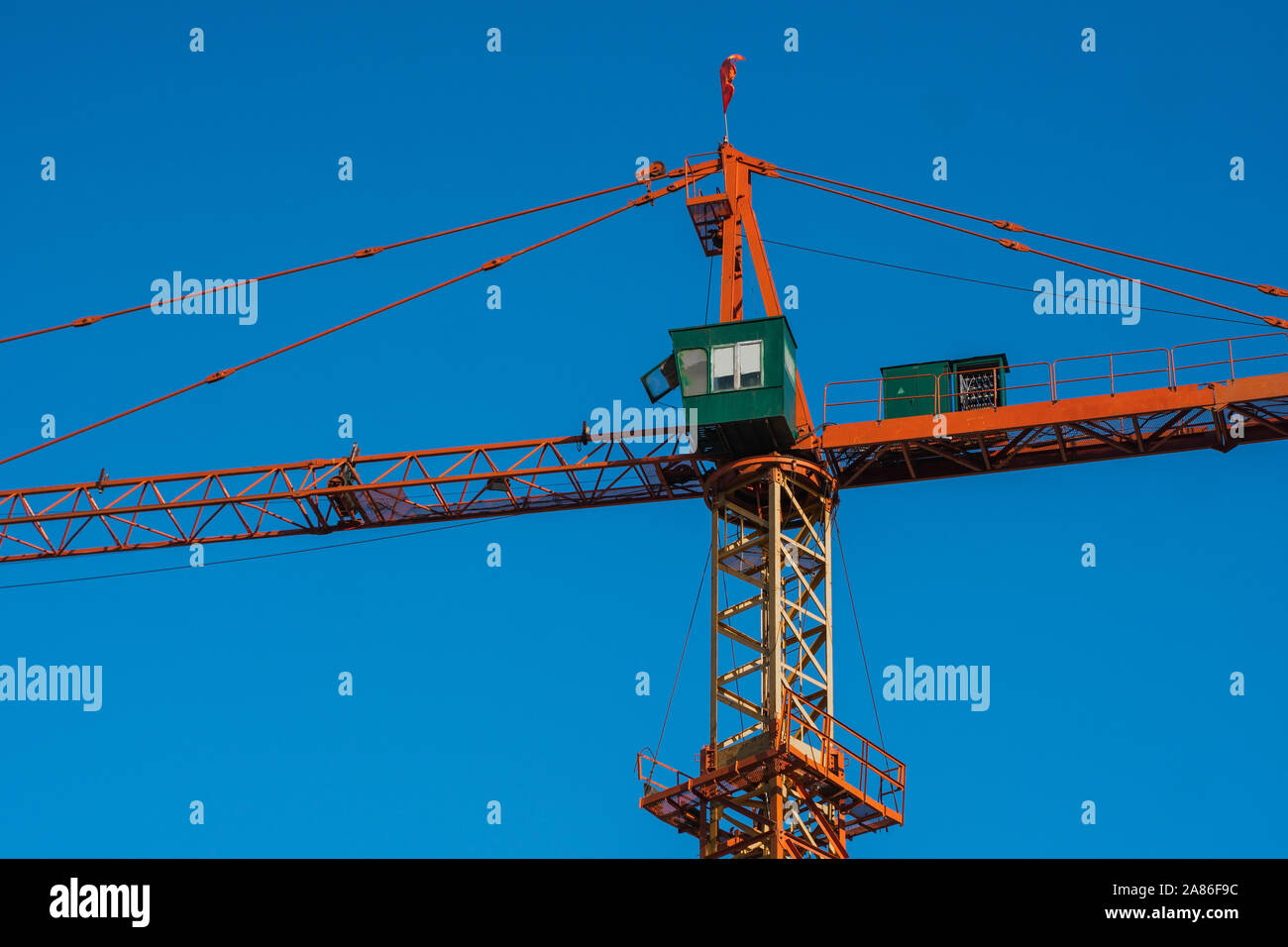 Tower crane against blue sky on a construction site for building of ...