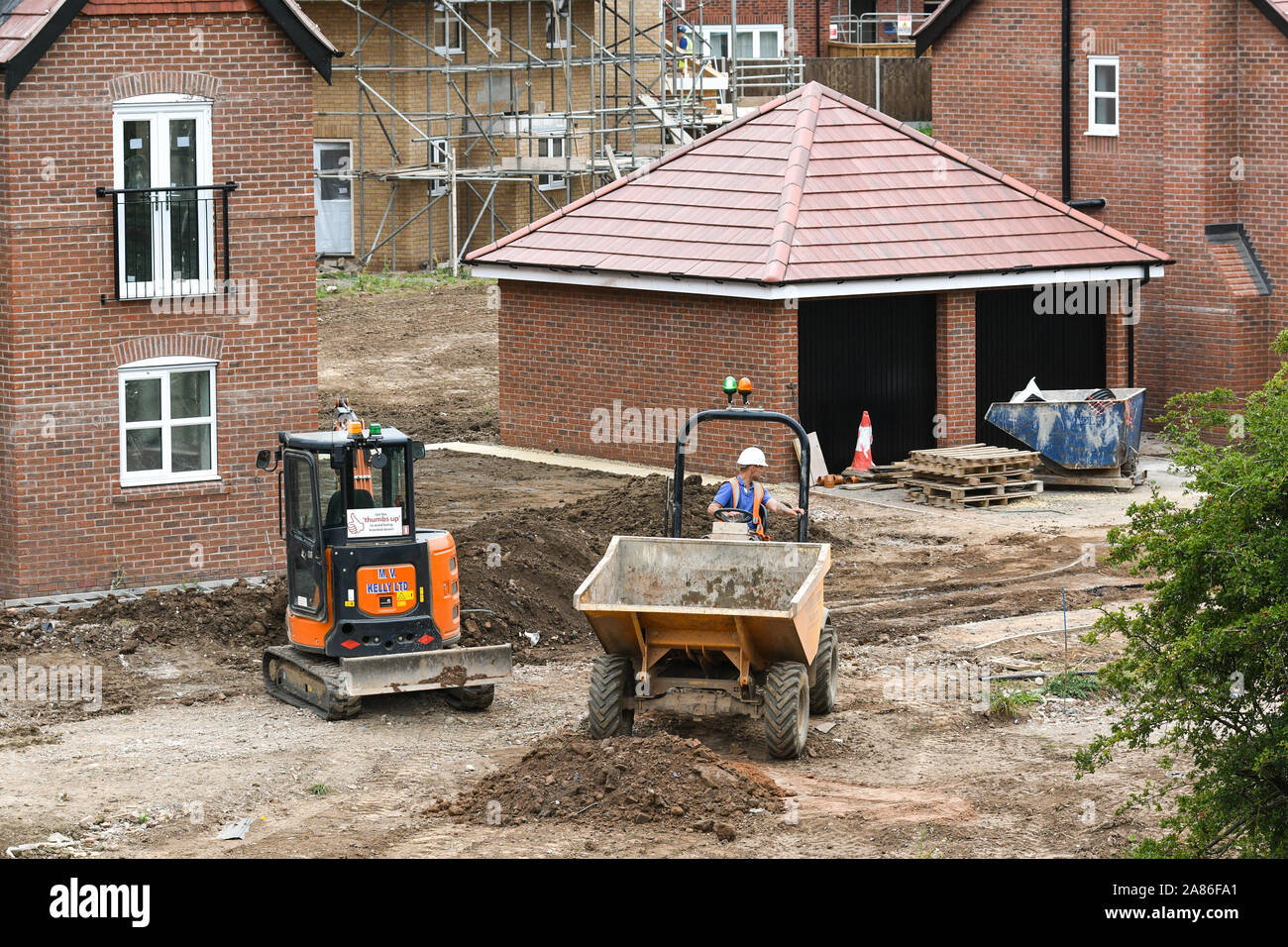 man driving a dumper truck on a building site Stock Photo - Alamy