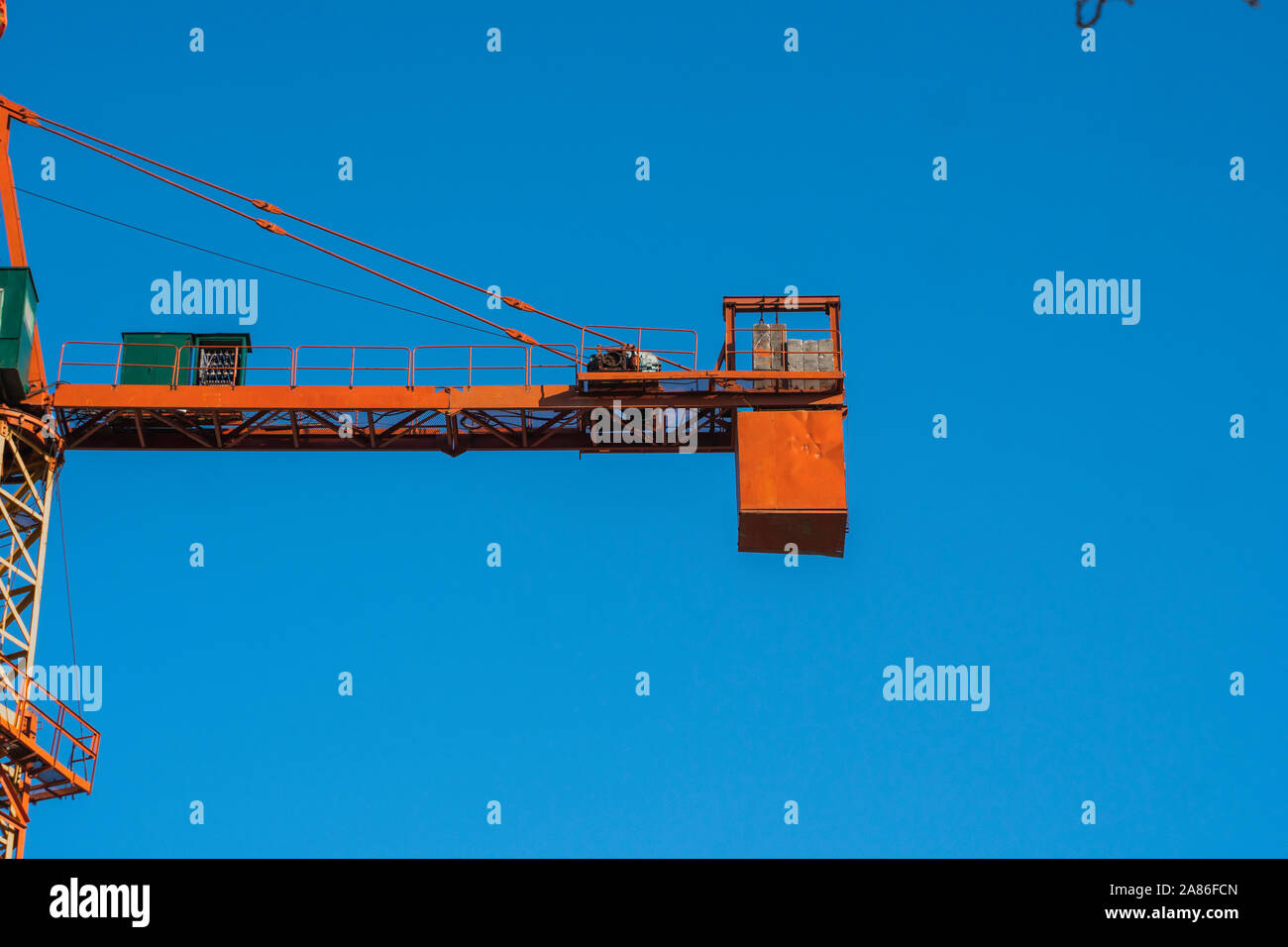 Tower crane against blue sky on a construction site for building of ...