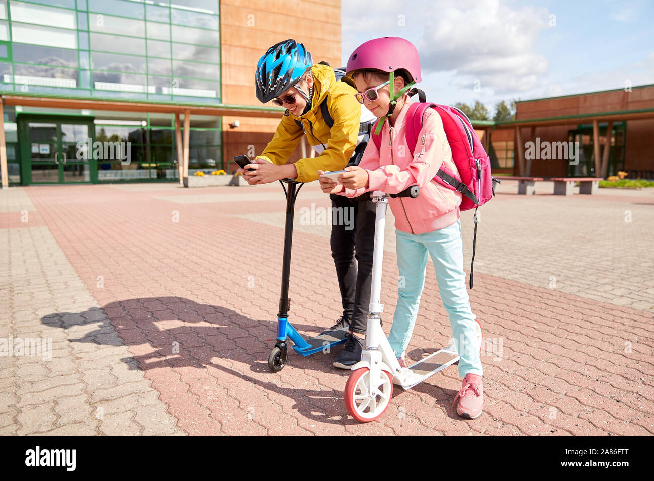 school children with smartphones and scooters Stock Photo - Alamy