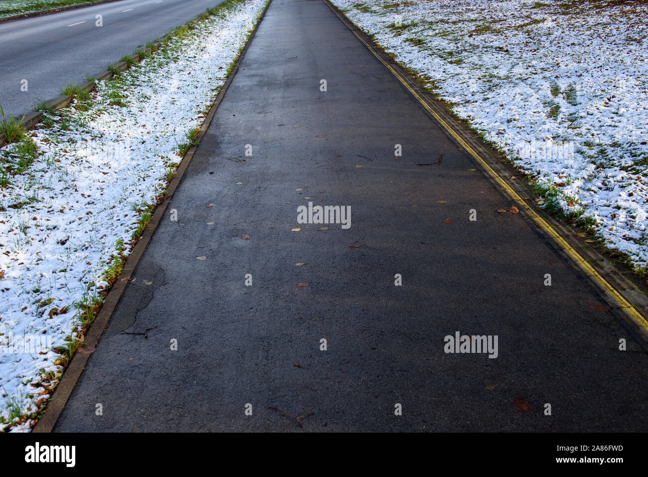 First snow in park. Asphalt pavement is clean of snow Stock Photo - Alamy