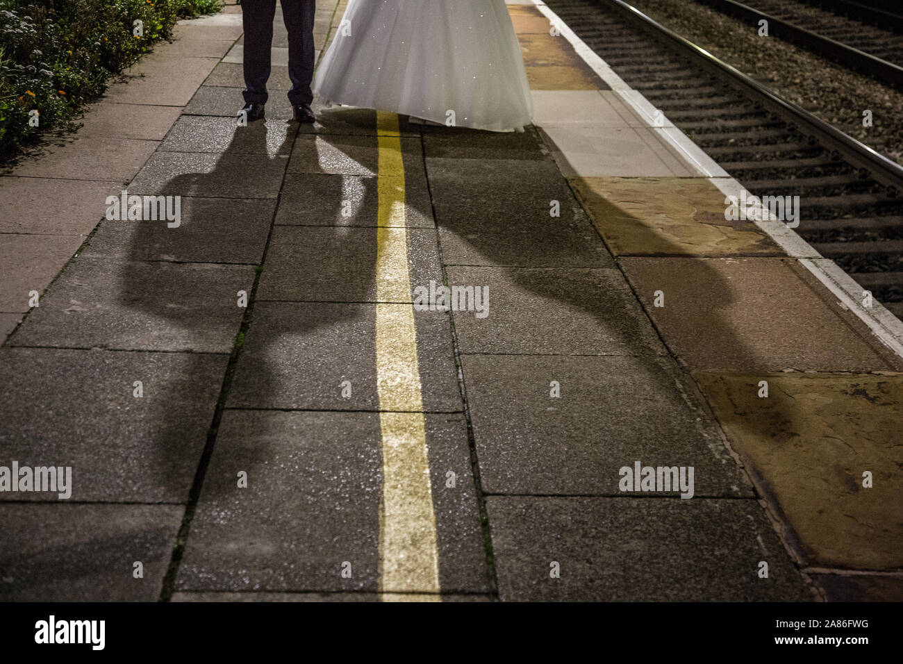shadows after dark of a bride and groom on their wedding day, no faces ...