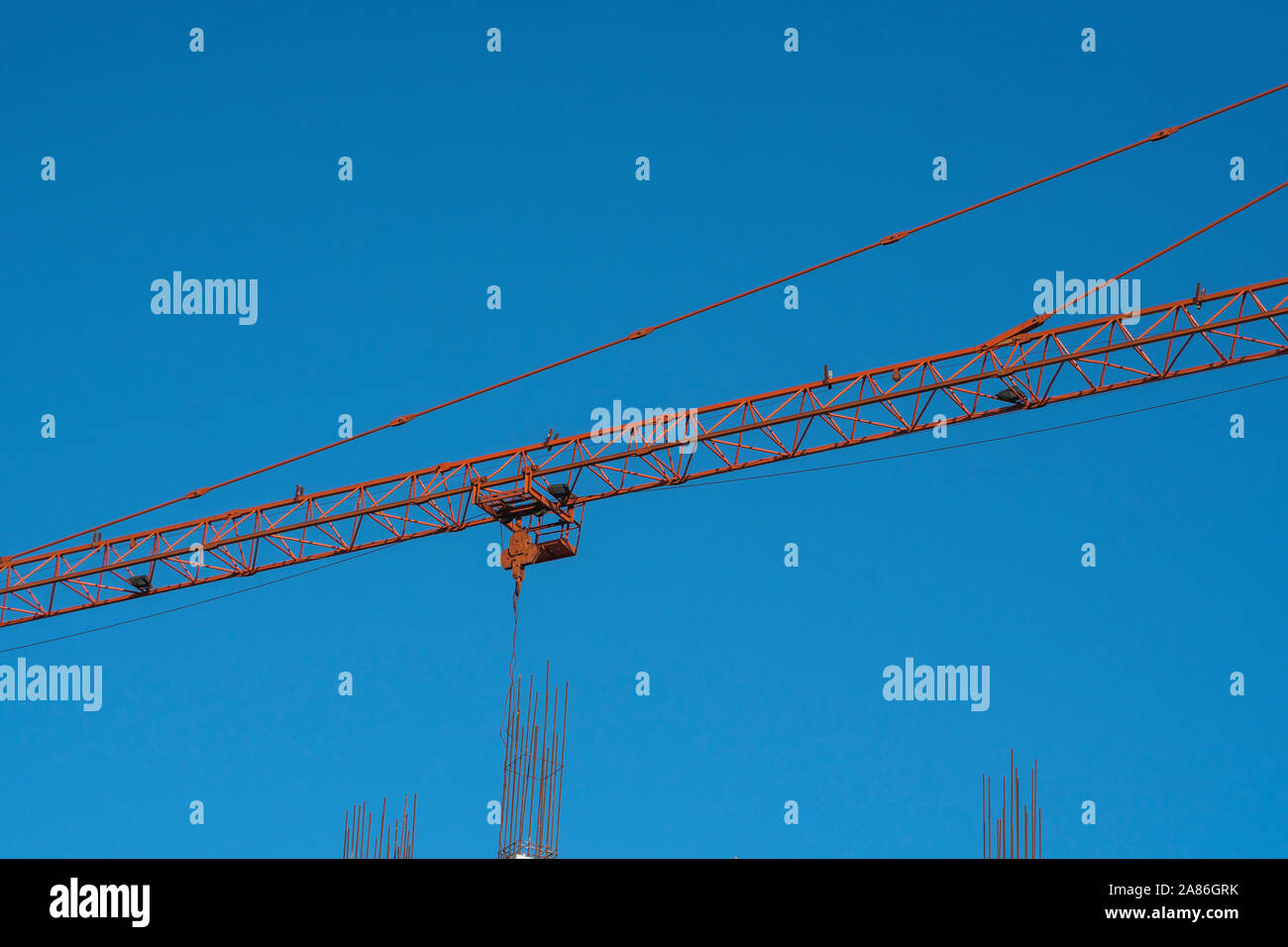 Tower crane against blue sky on a construction site for building of ...