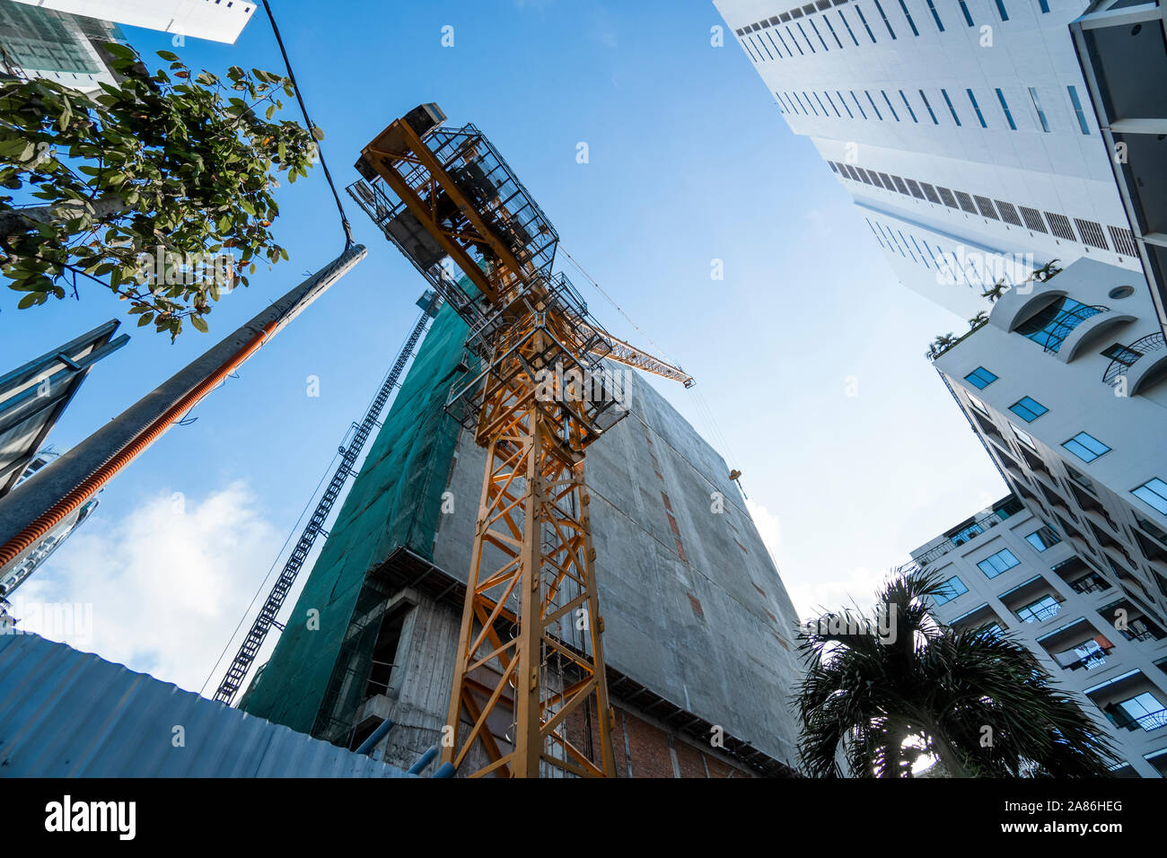 Crane and building construction site against blue sky. Metal ...