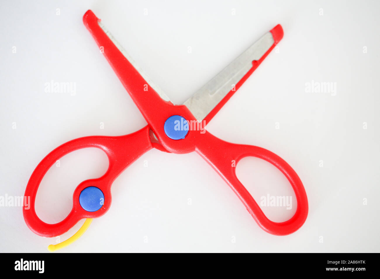 Red handle scissors placed on a white background - Image Stock Photo ...