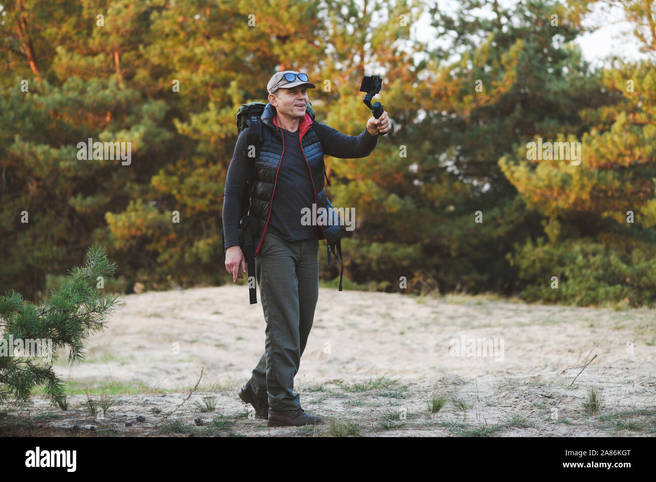 Male hiker making photo and video of beautiful locations with ...