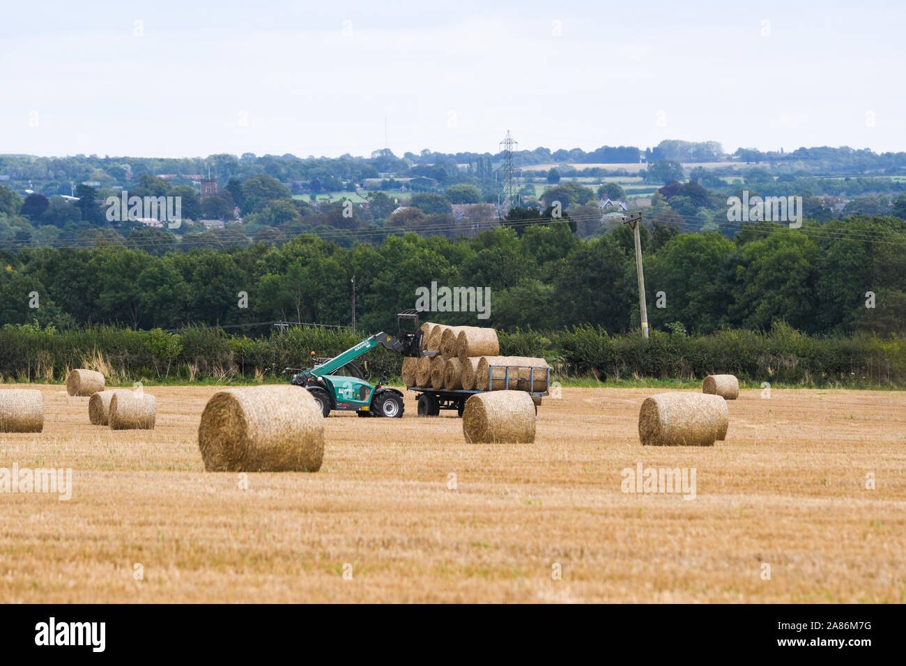 farmer collecting hay bales Stock Photo - Alamy