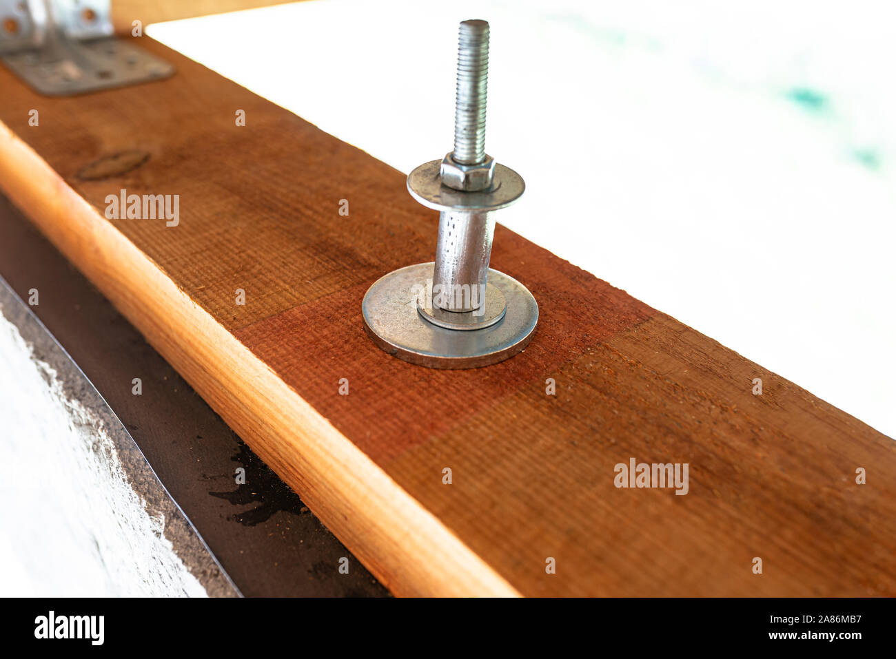 A long anchor bolt for fixing the roof made of trusses Stock Photo - Alamy