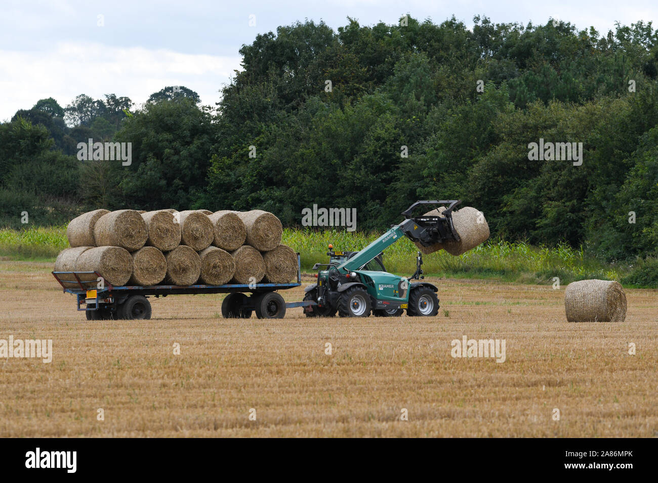farmer collecting hay bales Stock Photo - Alamy