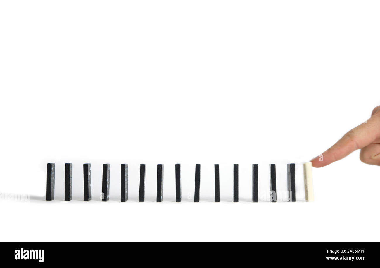 A man pushes a white Domino with his finger. Concept, not like everyone ...