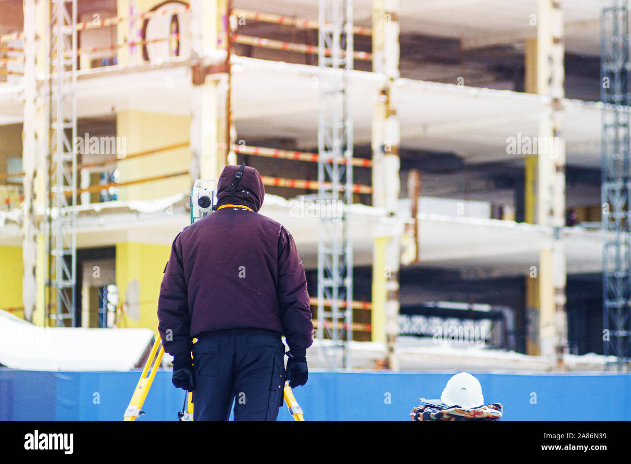 Surveyor engineer uses a total station at a construction site. Geodetic ...
