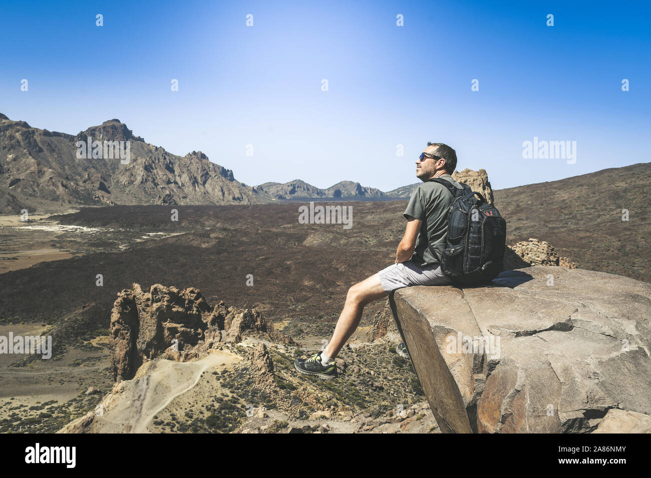 Man sitting top mountain overlooking hi-res stock photography and ...