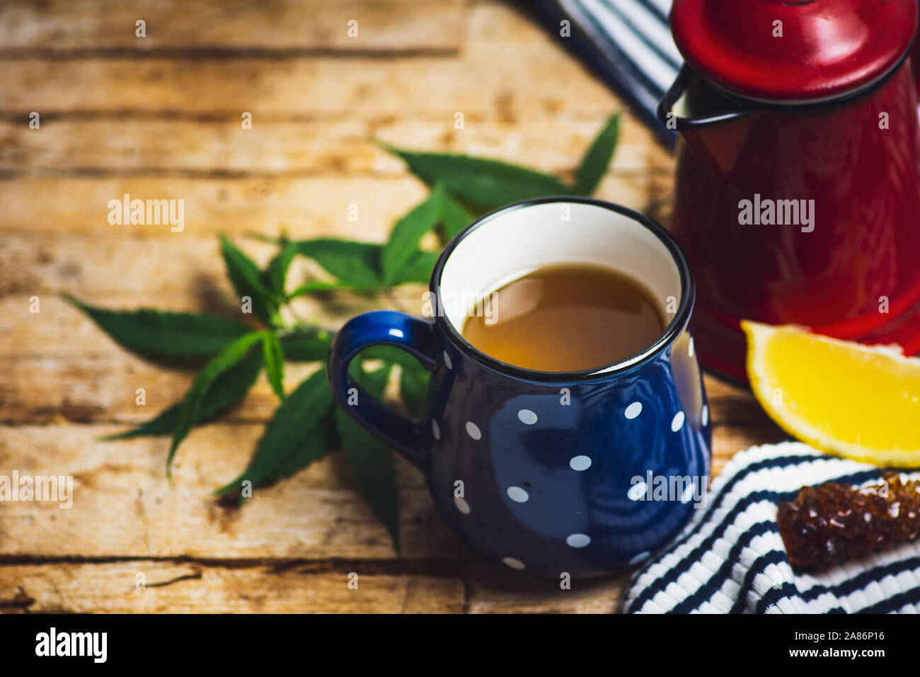 Marijuana herbal tea in colorful cups and cannabis leaves Stock Photo ...
